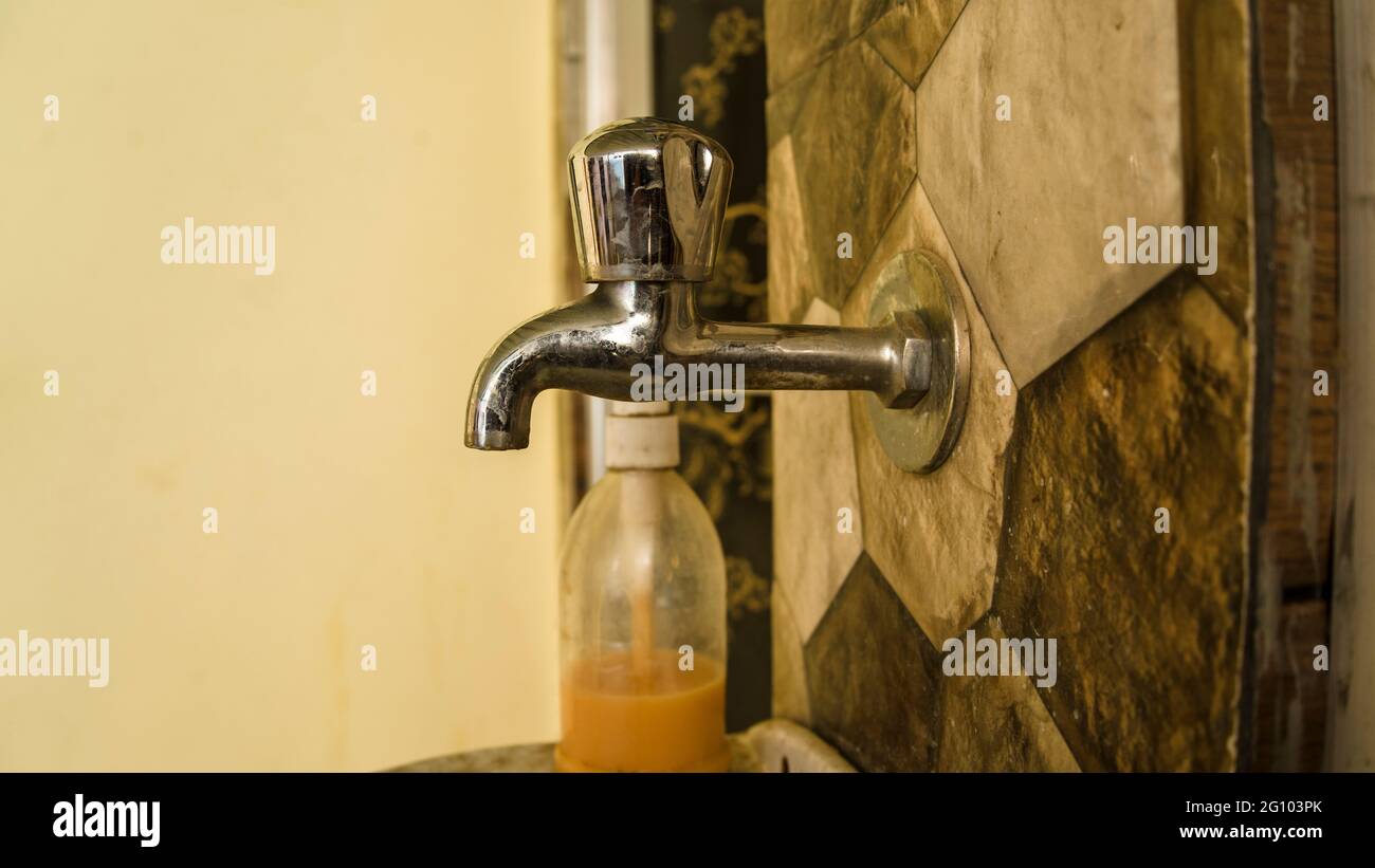 Stainless steel water tap and abstract tiles background. Modern clean ...
