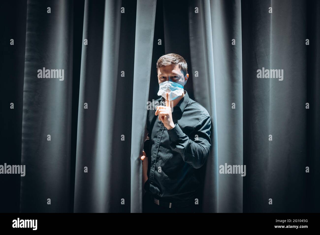 Do not speak too loud, please. Man makes hush gesture Stock Photo - Alamy