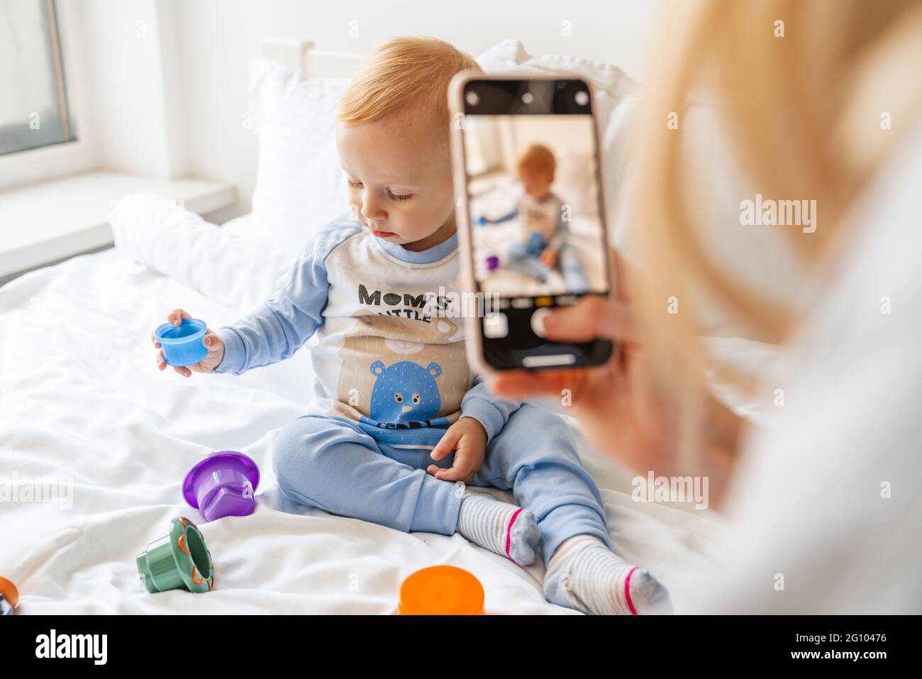 Mother taking photo of baby on phone hi-res stock photography and ...