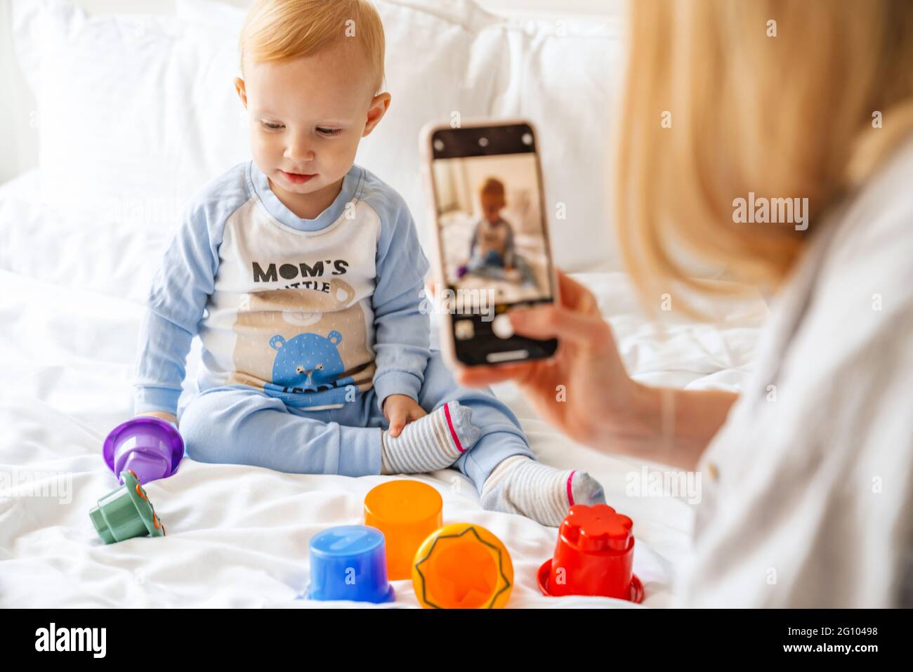 Mother taking photo of baby on phone hi-res stock photography and ...