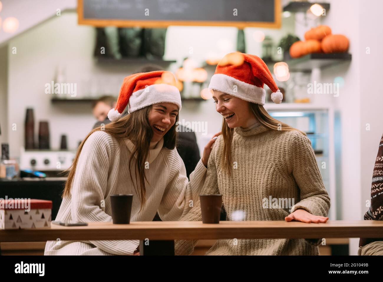 Portrait of happy cute young friends having fun in cafe Stock Photo - Alamy