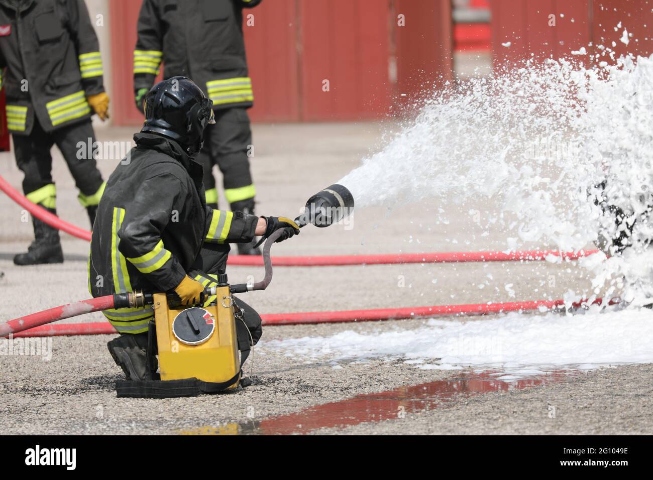 firefighters with the special flame retardant foam extinguish a fire ...