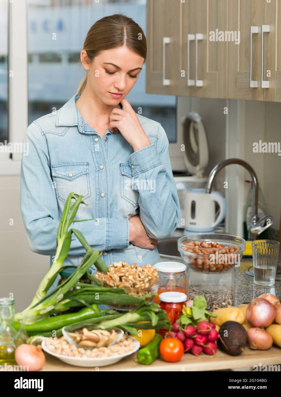 Sad tired young woman in the kitchen Stock Photo - Alamy
