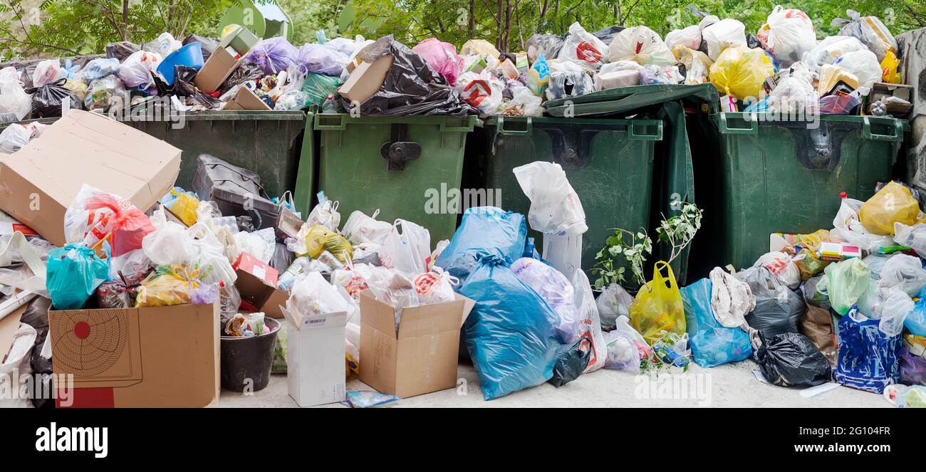 Overloaded dumpster, full garbage container, household garbage bin ...