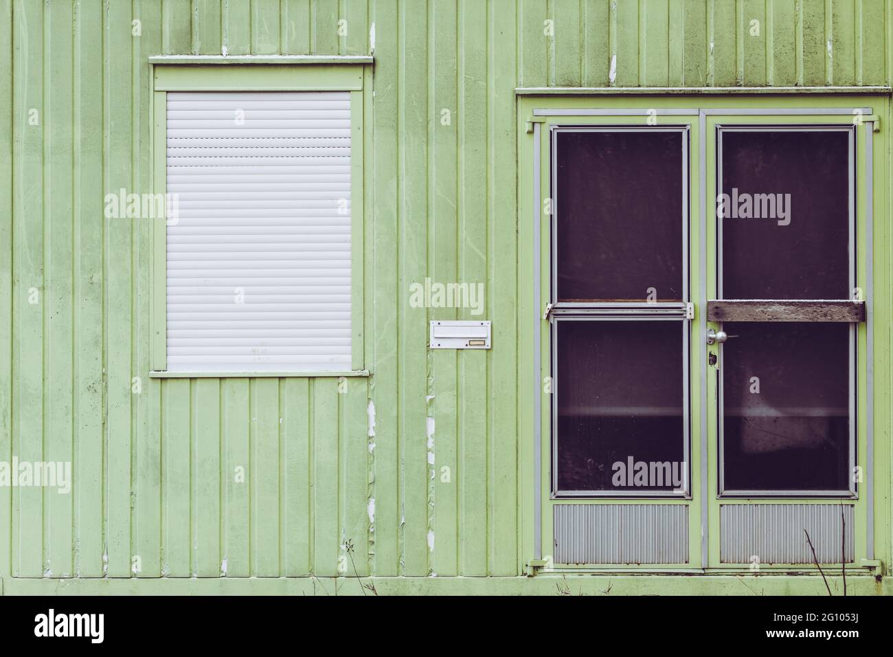 Closeup shot of a beautiful light green building with a window and ...