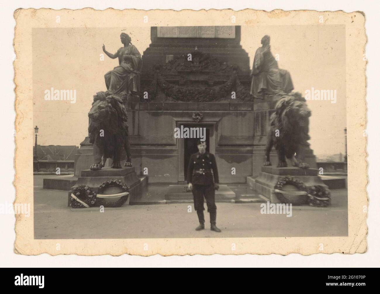 Man in uniform at a monument; NSB. Man in uniform (wa?) Stands for a ...