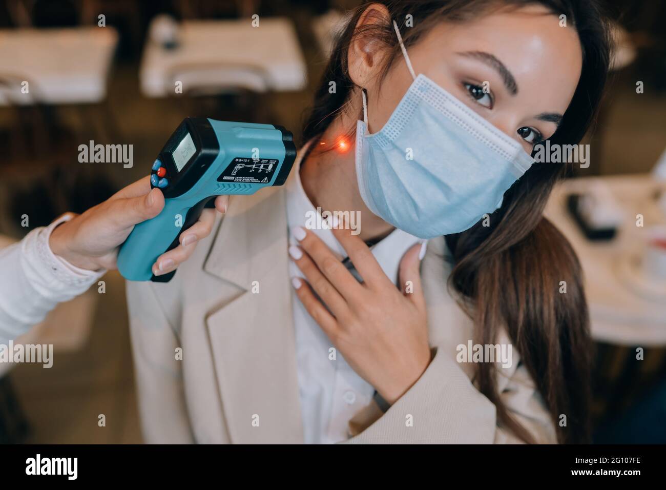 Measuring body temperature with contactless body thermometer Stock ...
