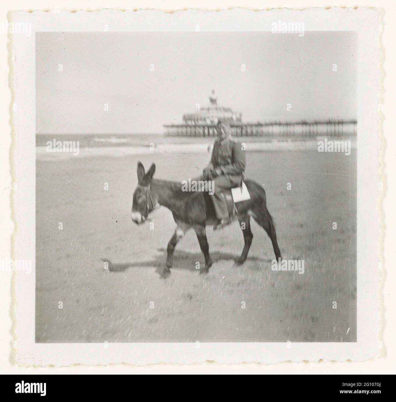 A Wehrmacht soldier rides a donkey. A Wehrmacht soldier has been ...