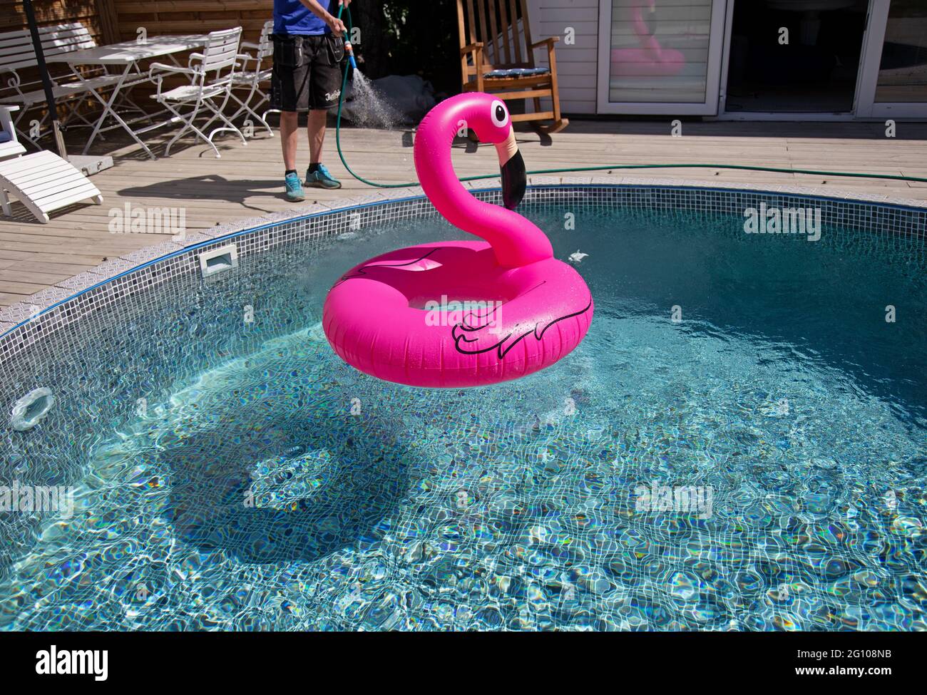 Someone refilling water in a pool in a garden Stock Photo - Alamy
