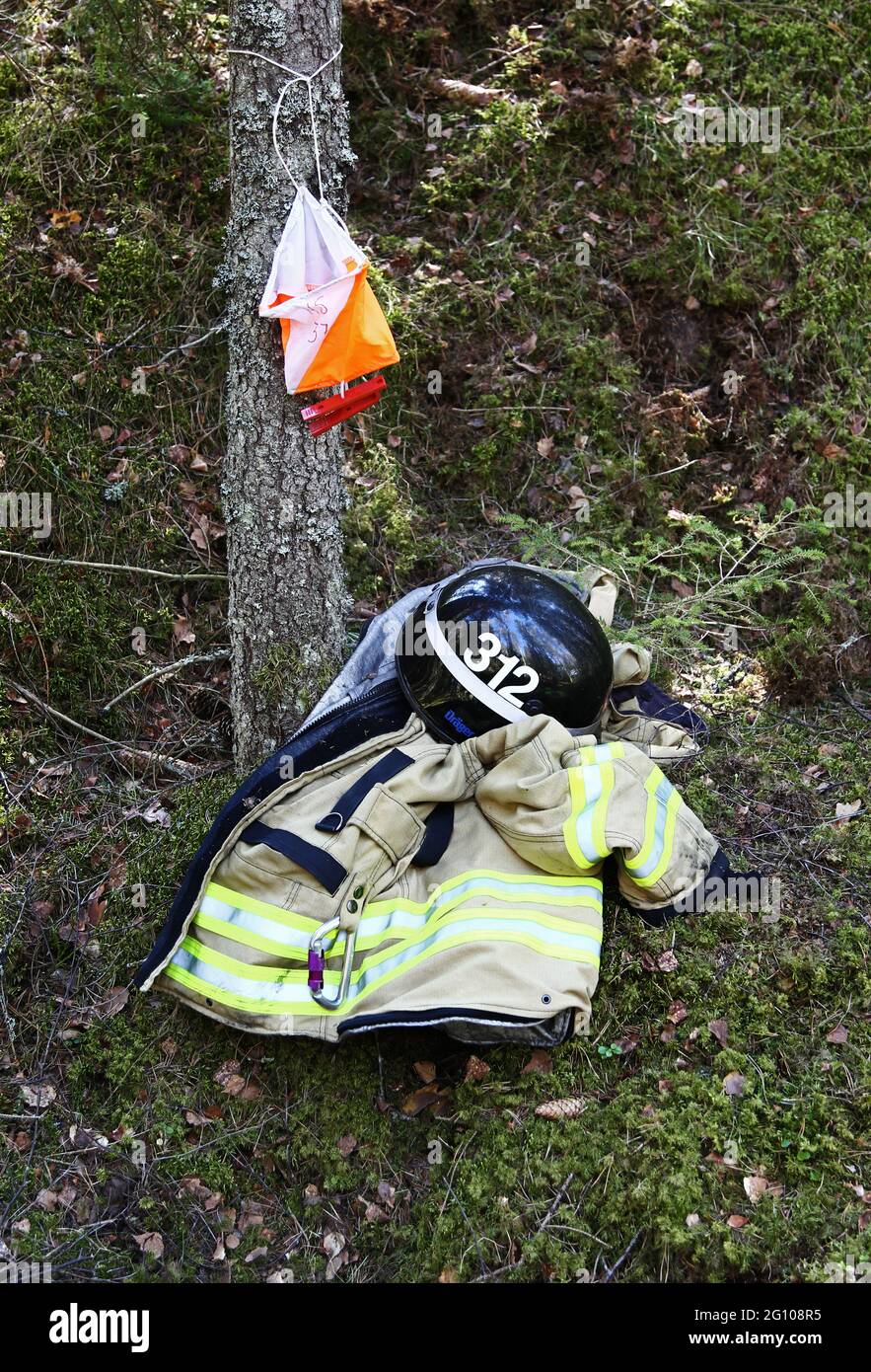 Firefighter's clothes at an orienteering check out in the woods during ...