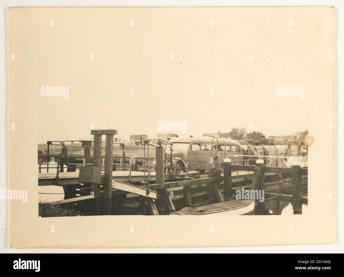 Wehrmacht soldiers at a bus. With a bus on a bridge there are some ...