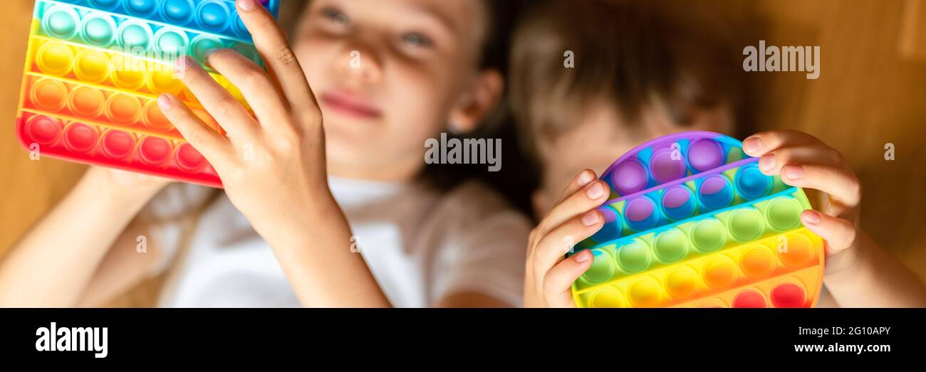 anti stress sensory pop it toys in a children's hands. a little happy ...