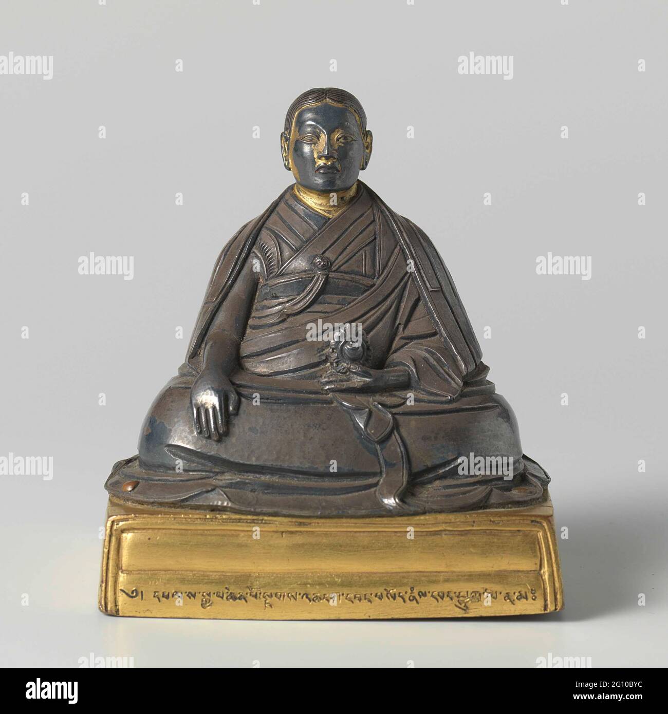 Sitting monk. Image of a lama. The lush pleated cloak, piping and ...