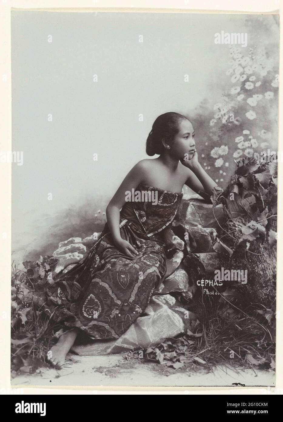 Studio portrait of a sitting young Javanese woman. Studio portrait of a ...