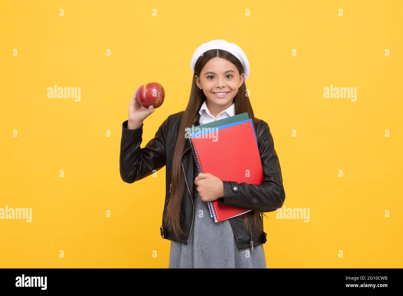 Apple for school snack. Schoolchild hold apple yellow background. Back ...