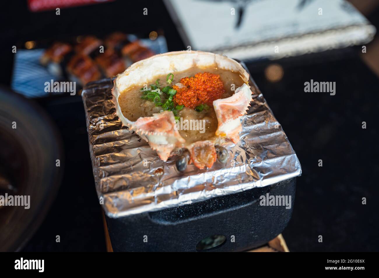 Kani Miso with Ebiko shrimp roe in crab shell grilling on japanese ...