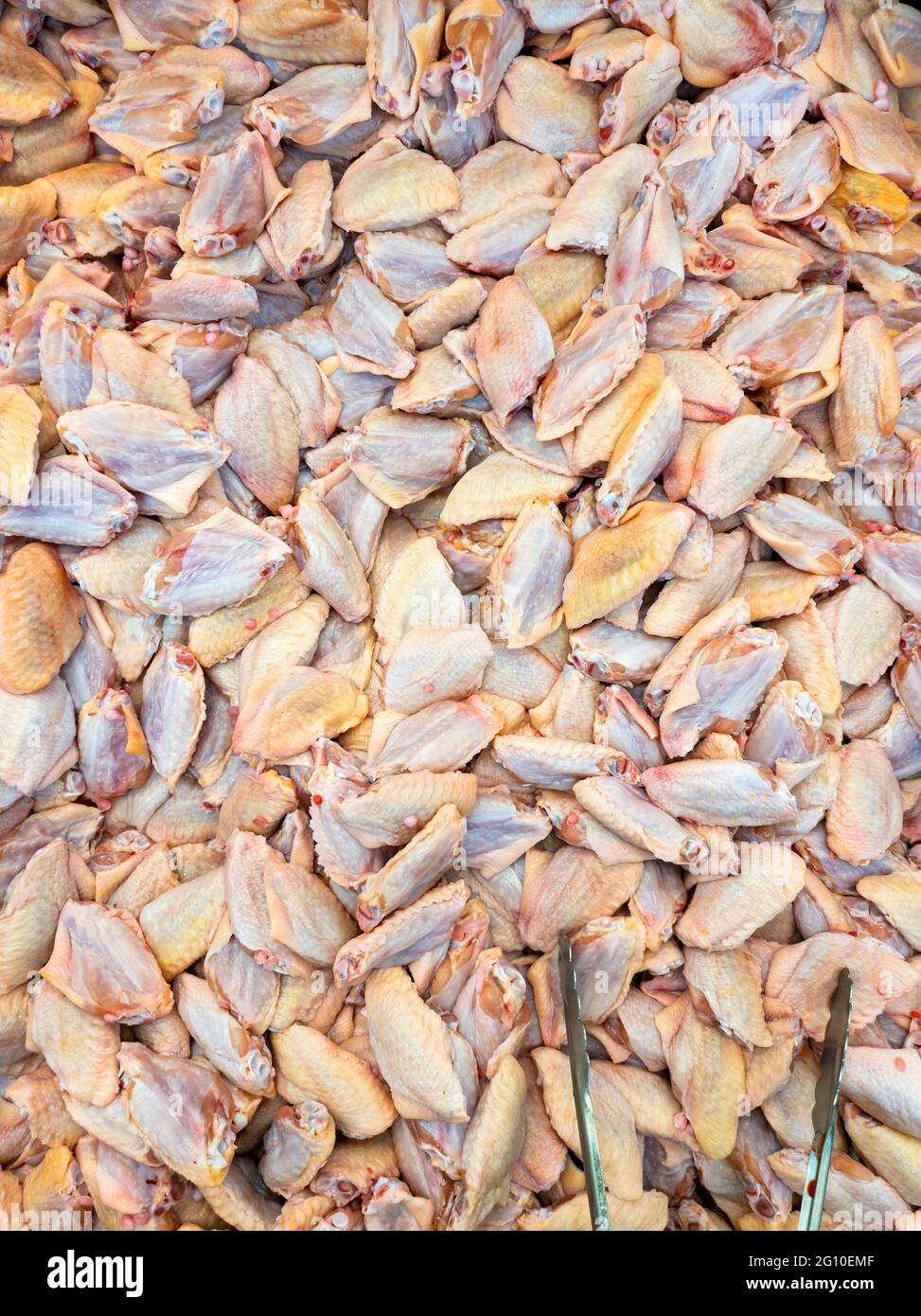 Raw chicken wings pile up on market stall Stock Photo - Alamy
