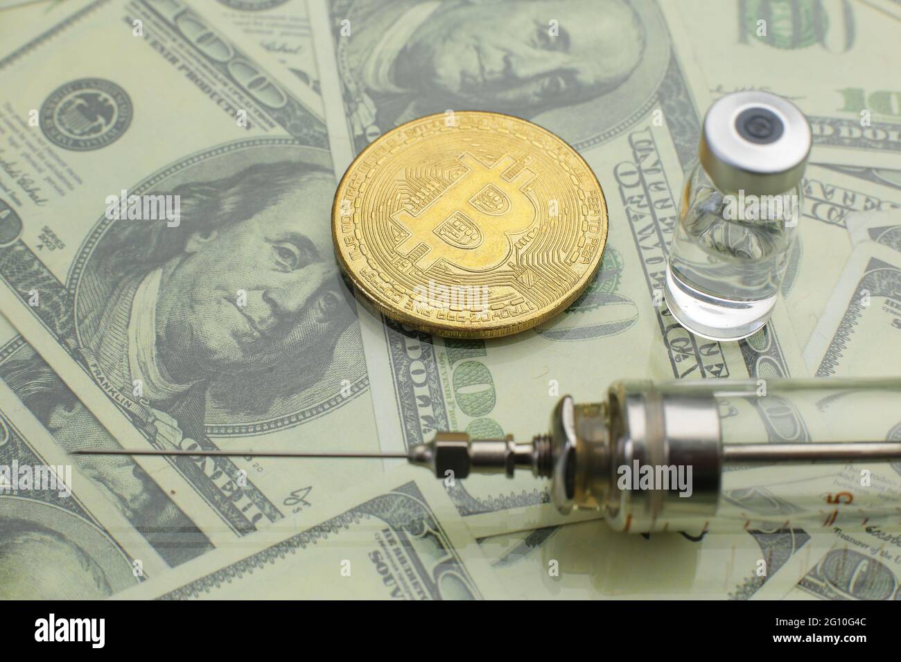 Bitcoin glass syringe and medical vaccine vial on american dollars ...