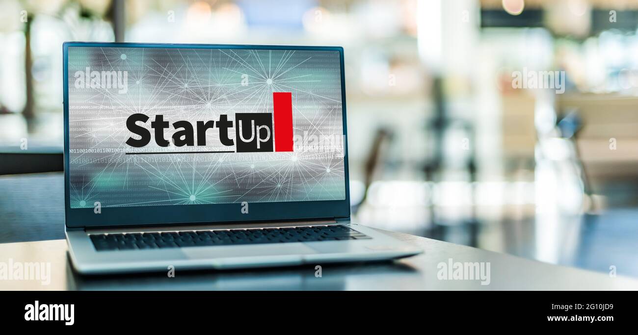 Laptop computer displaying the sign of StartUp Stock Photo - Alamy