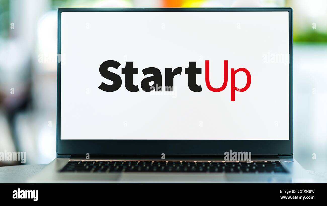 Laptop computer displaying the sign of StartUp Stock Photo - Alamy