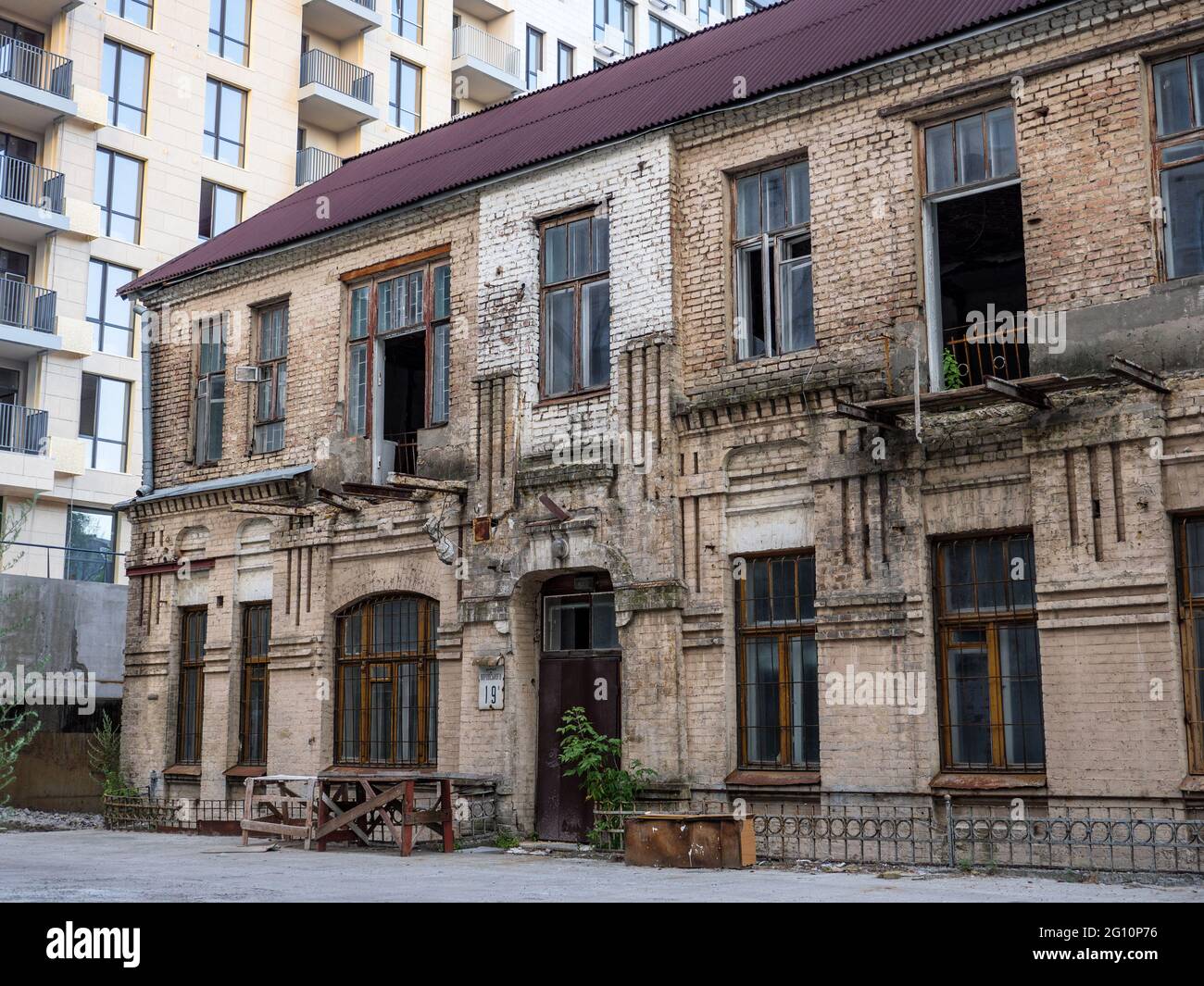 The exterior of an old half-ruined two-story forsaken brick building in ...