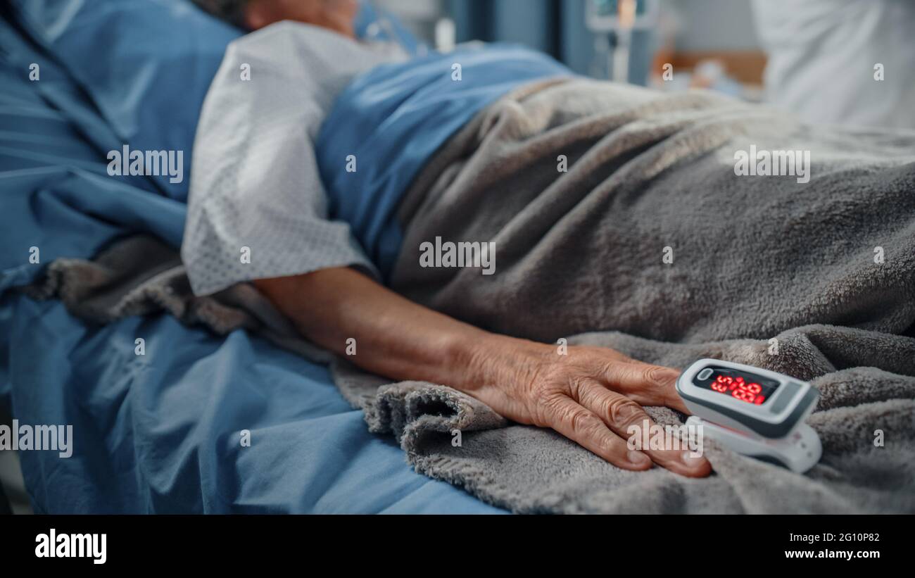 Hospital Ward: Senior Woman Resting in a bed with Finger Heart Rate ...