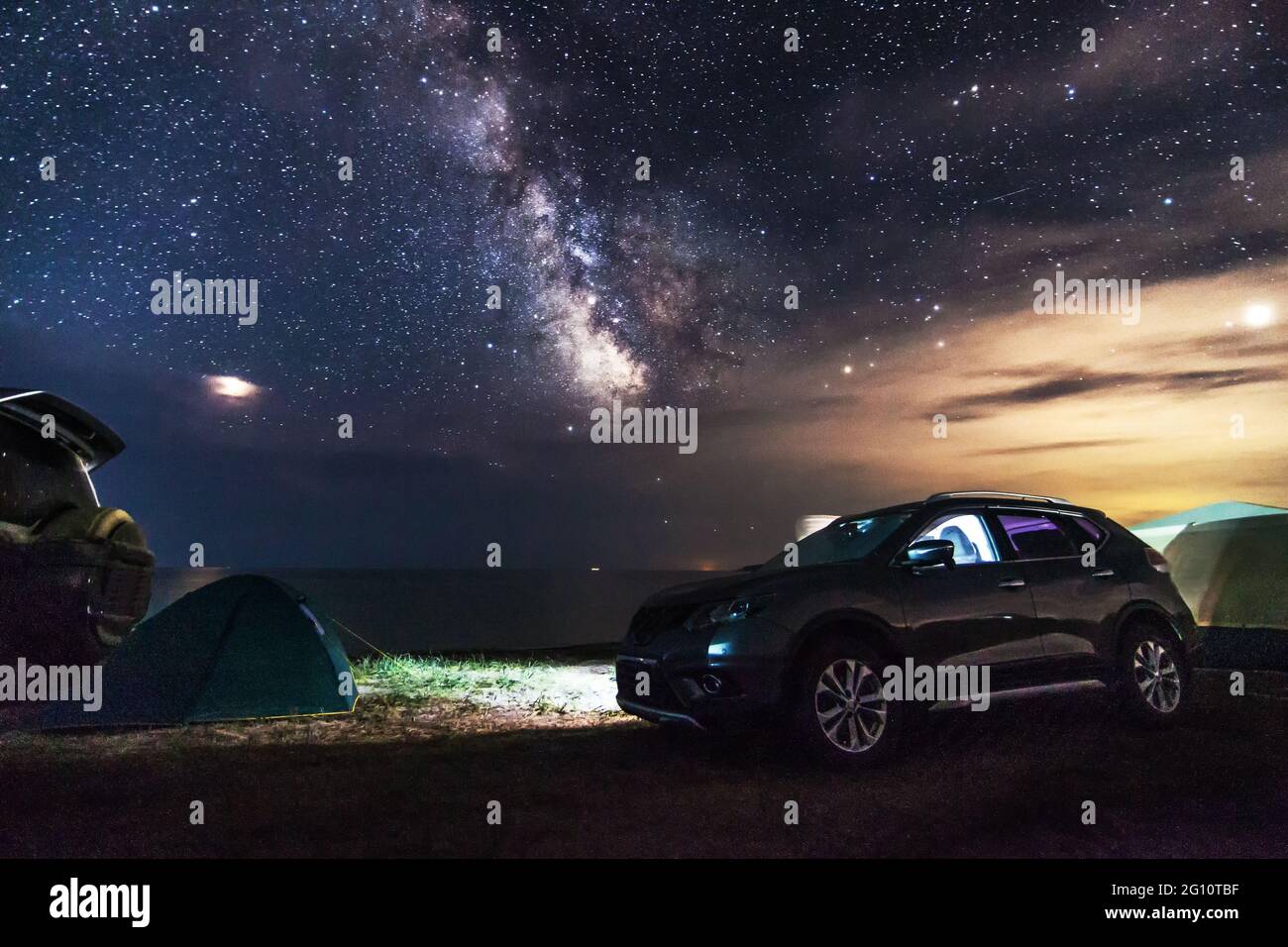 Camping at the sea beach under night sky Stock Photo - Alamy
