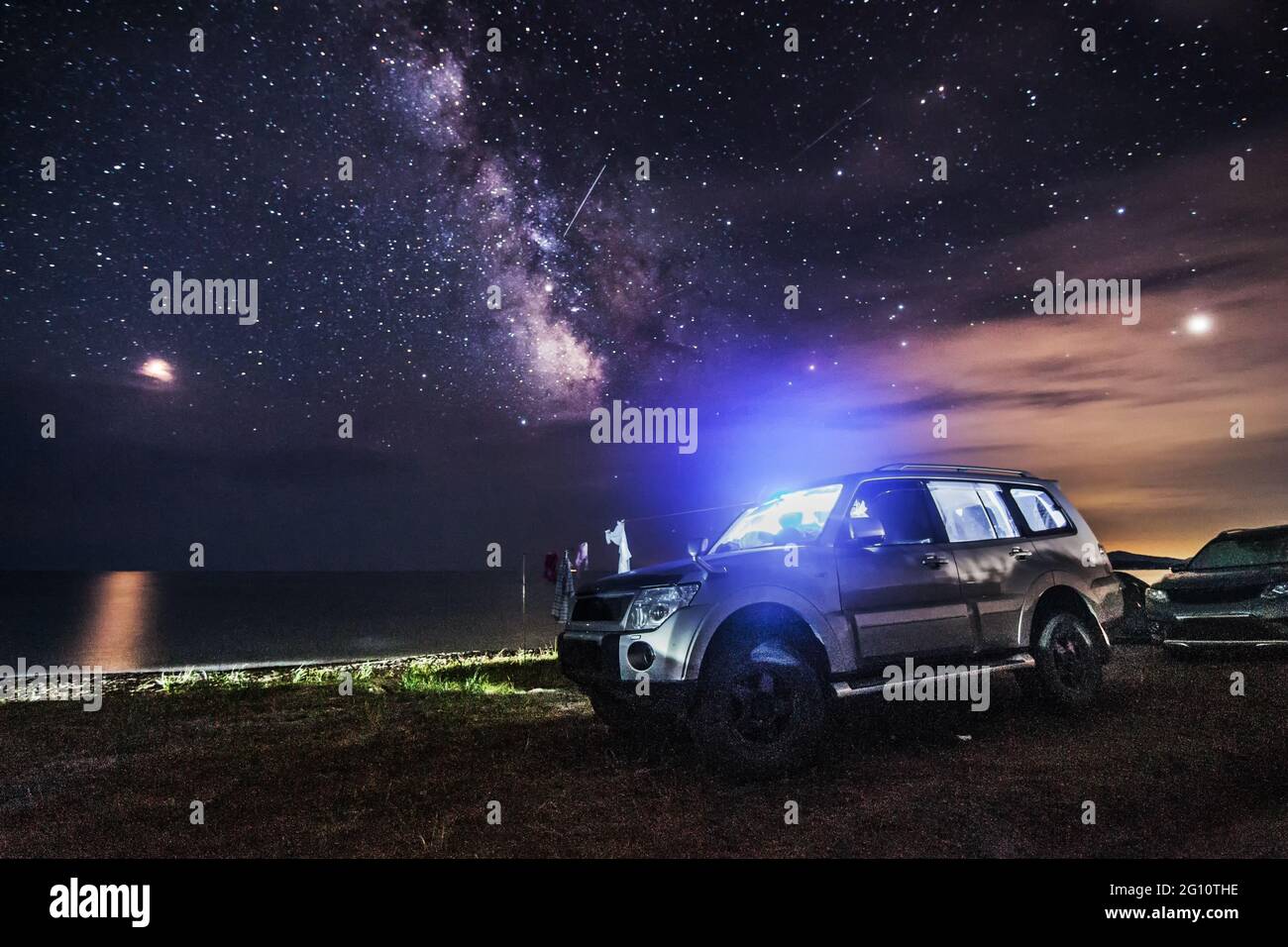 Camping at the sea beach under night sky Stock Photo - Alamy
