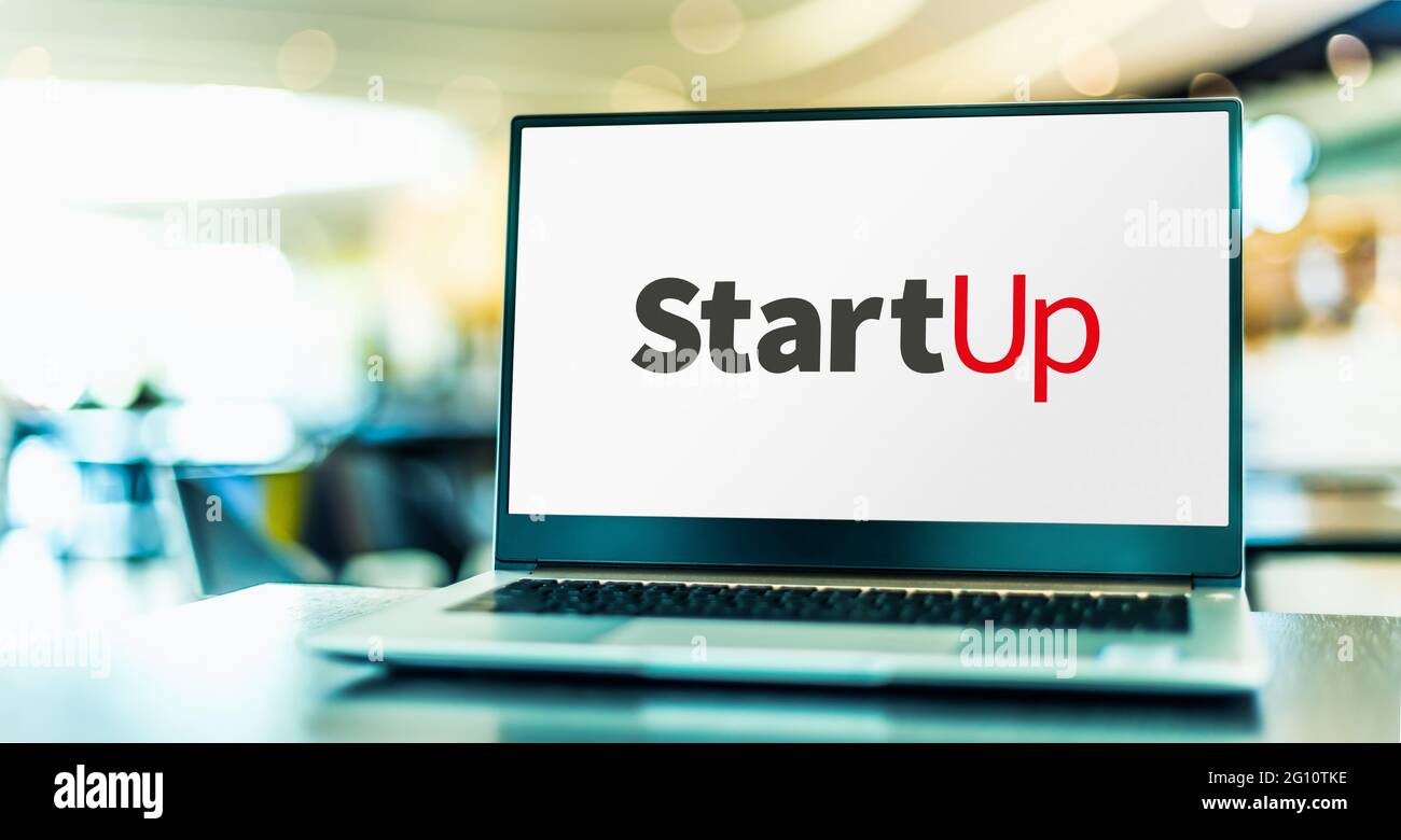 Laptop computer displaying the sign of StartUp Stock Photo - Alamy