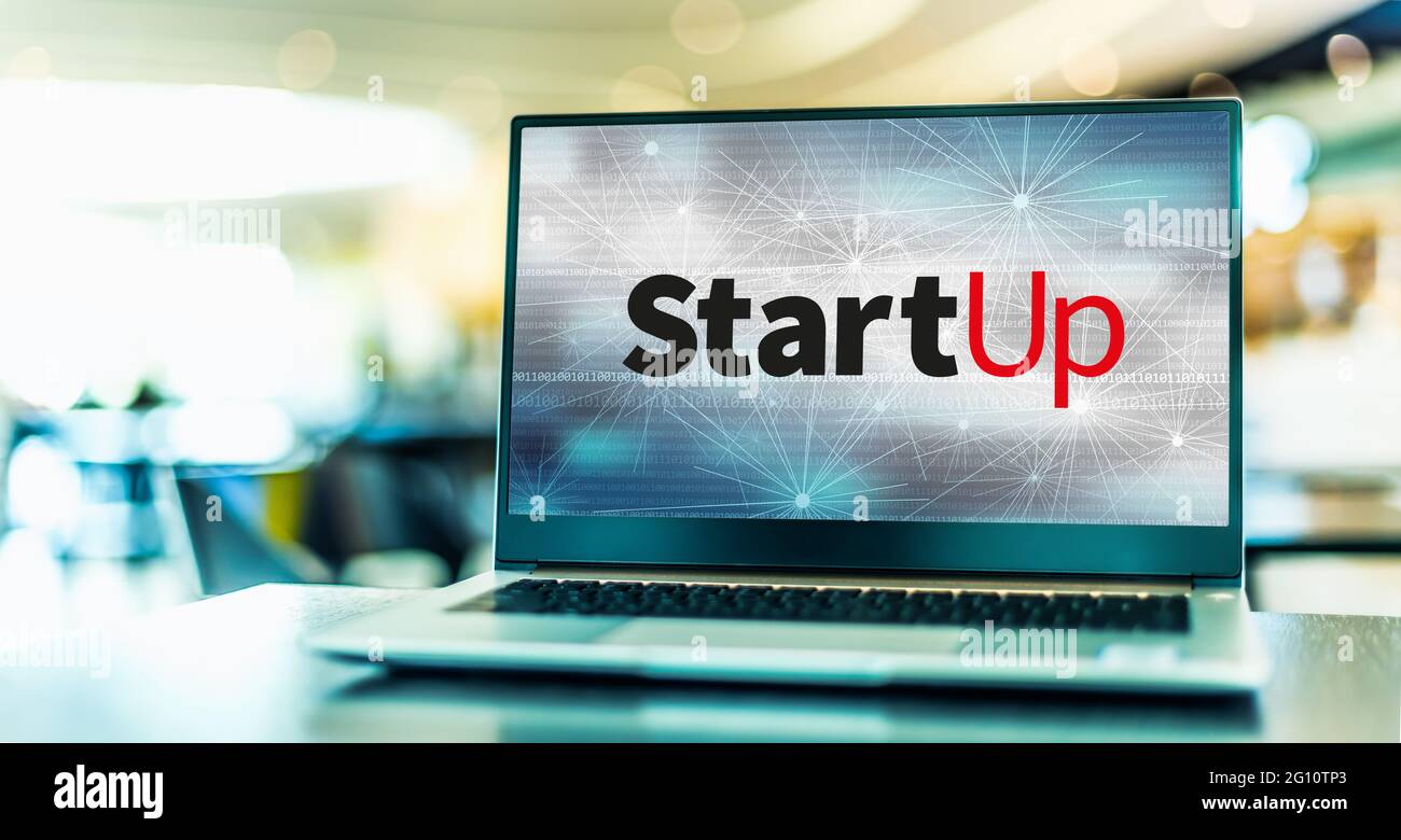 Laptop computer displaying the sign of StartUp Stock Photo - Alamy