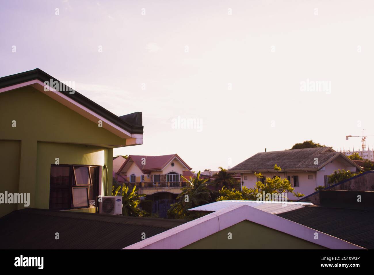 Modern homes in a peaceful Filipino suburb, captured during golden hour ...