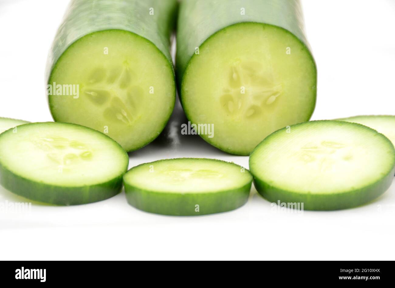closeup the pair of sliced green ripe cucumber isolated on white ...