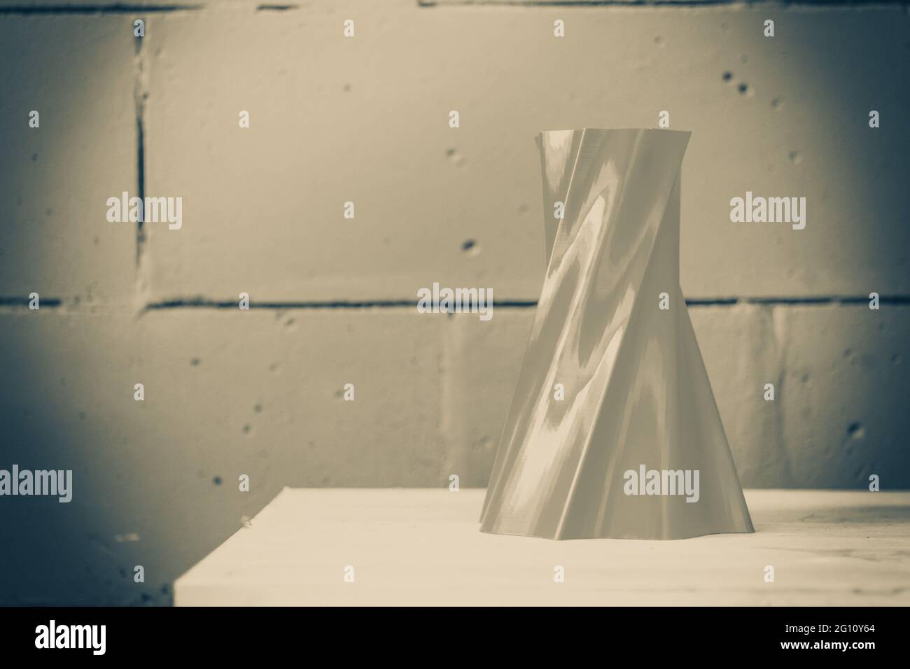 Bright red object vase printed by 3d printer on blue brick wall Stock ...