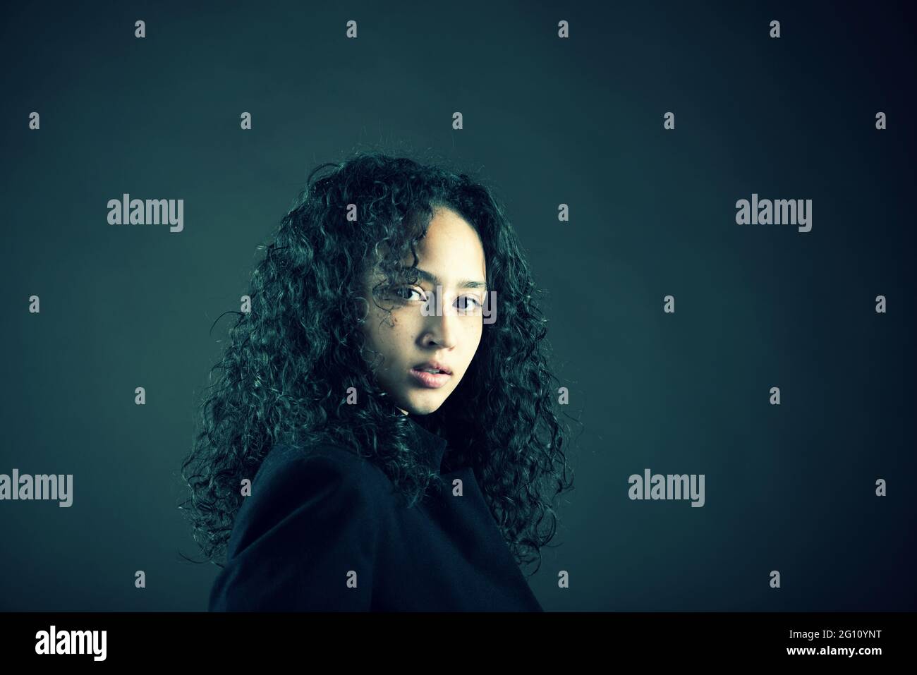 Portrait of fragile, very attractive and mysterious young woman. Studio ...