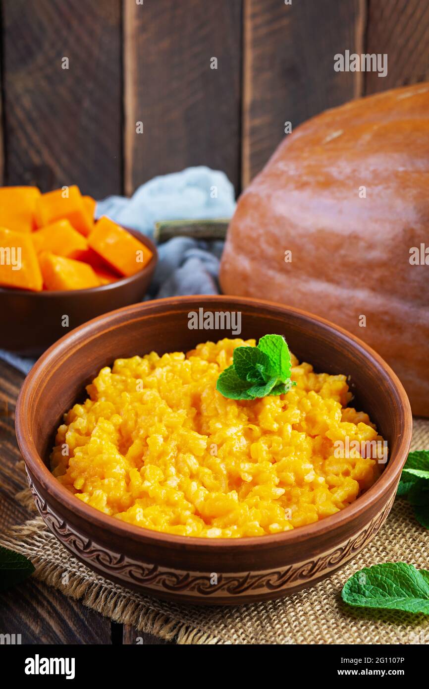 Delicious homemade pumpkin porridge on wooden background. Healthy vegan ...