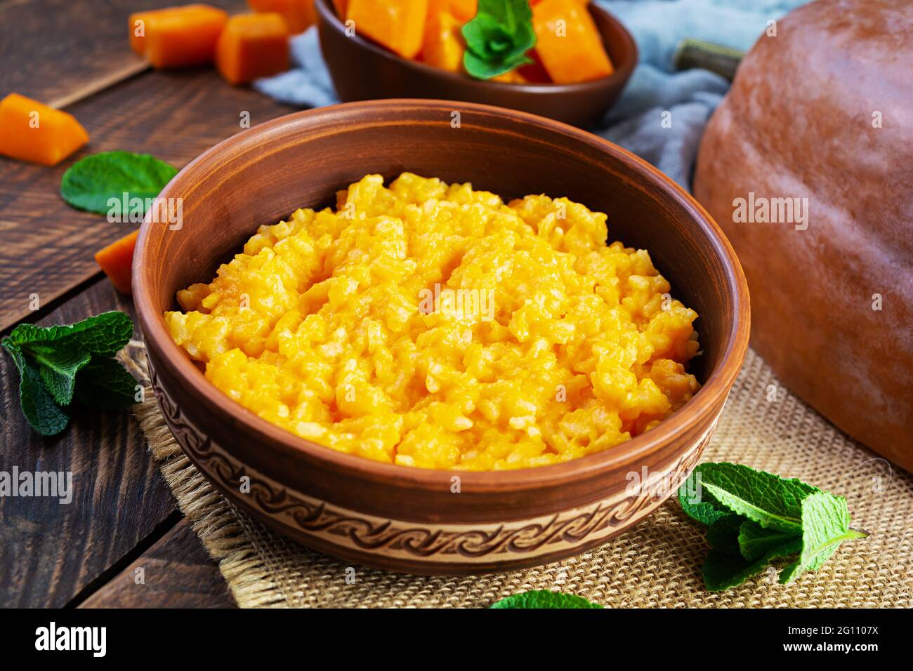 Delicious homemade pumpkin porridge on wooden background. Healthy vegan ...