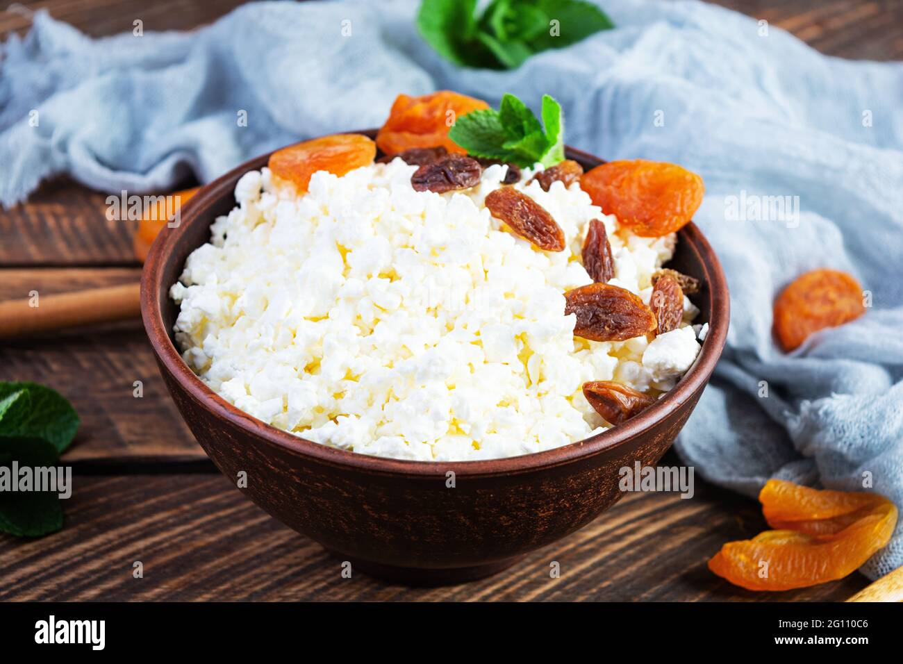 Healthy breakfast cottage cheese with raisins, dried apricots, almond ...