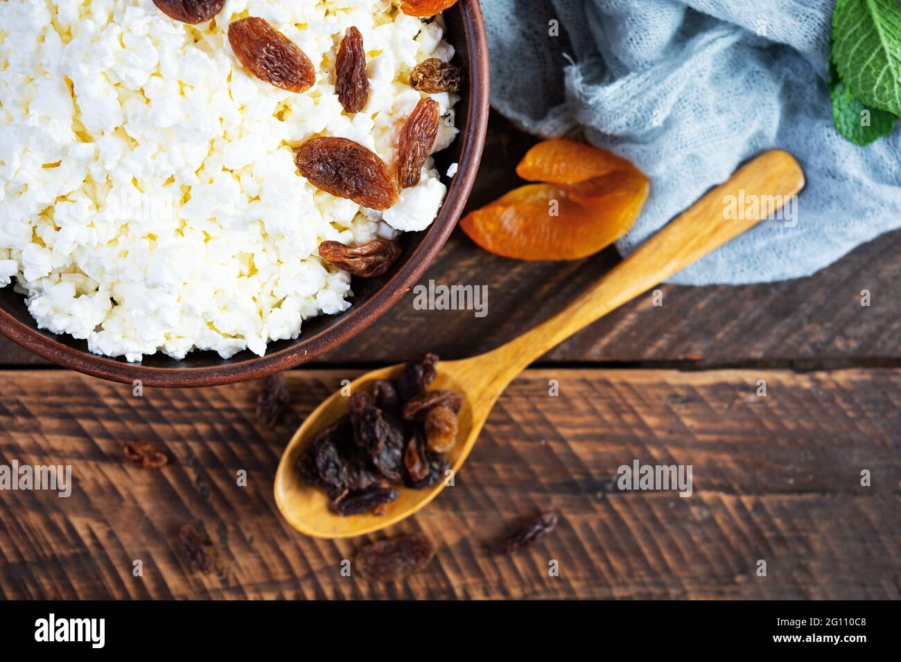 Healthy breakfast cottage cheese with raisins, dried apricots, almond ...
