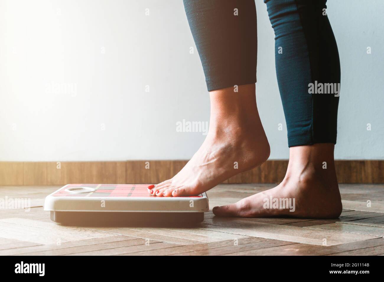 Female checking kilogrammes getting on the scale - self care and body ...