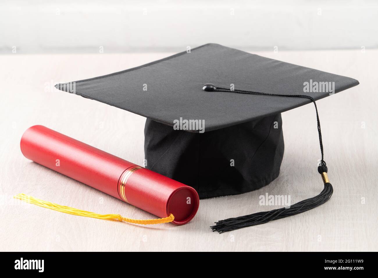 Close up of graduation square academic cap with degree diploma on ...