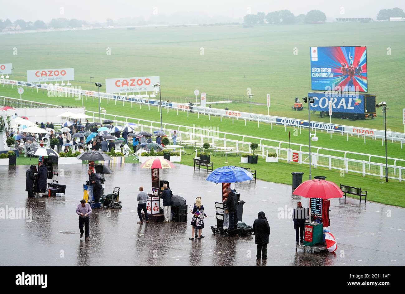 Racegoers place bets at the track side bookmaker stands during day one ...