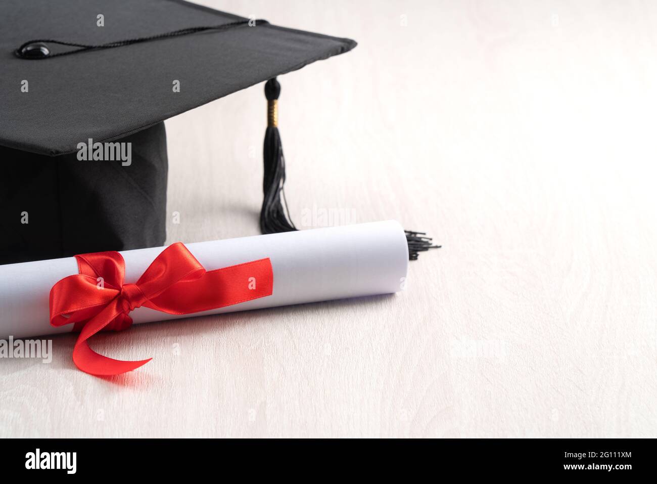 Close up of graduation square academic cap with degree diploma on ...
