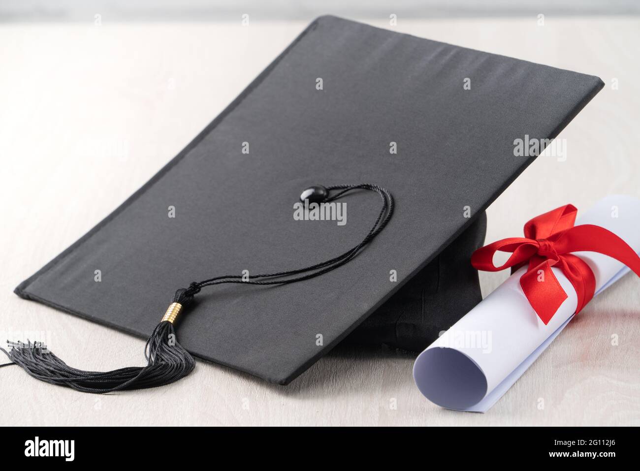 Close up of graduation square academic cap with degree diploma on ...