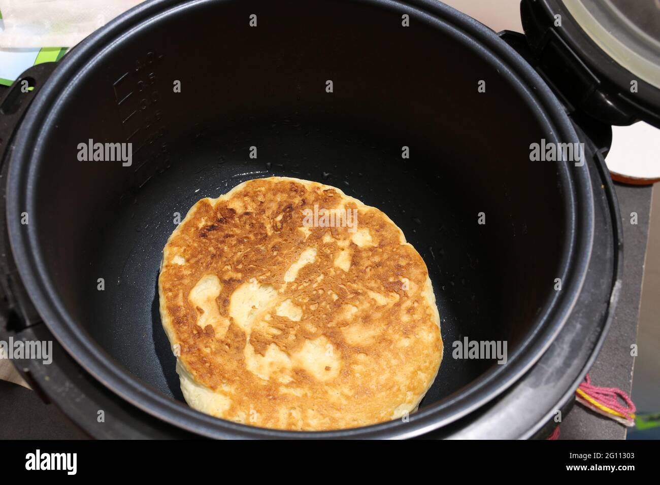 Baking flatbread in the multicooker kitchen machine Stock Photo - Alamy