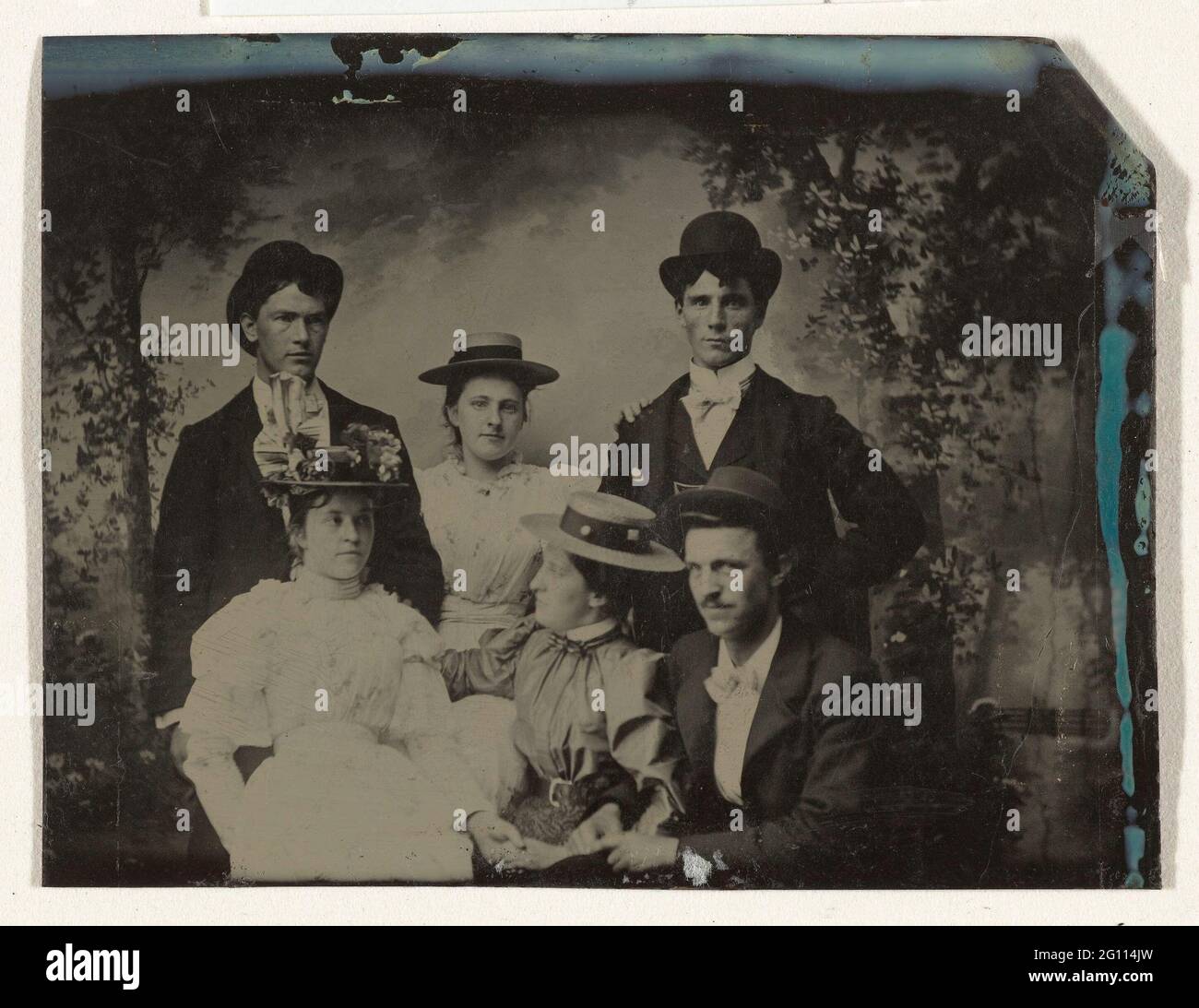 Group portrait of three men and three women, sitting in a studio with ...