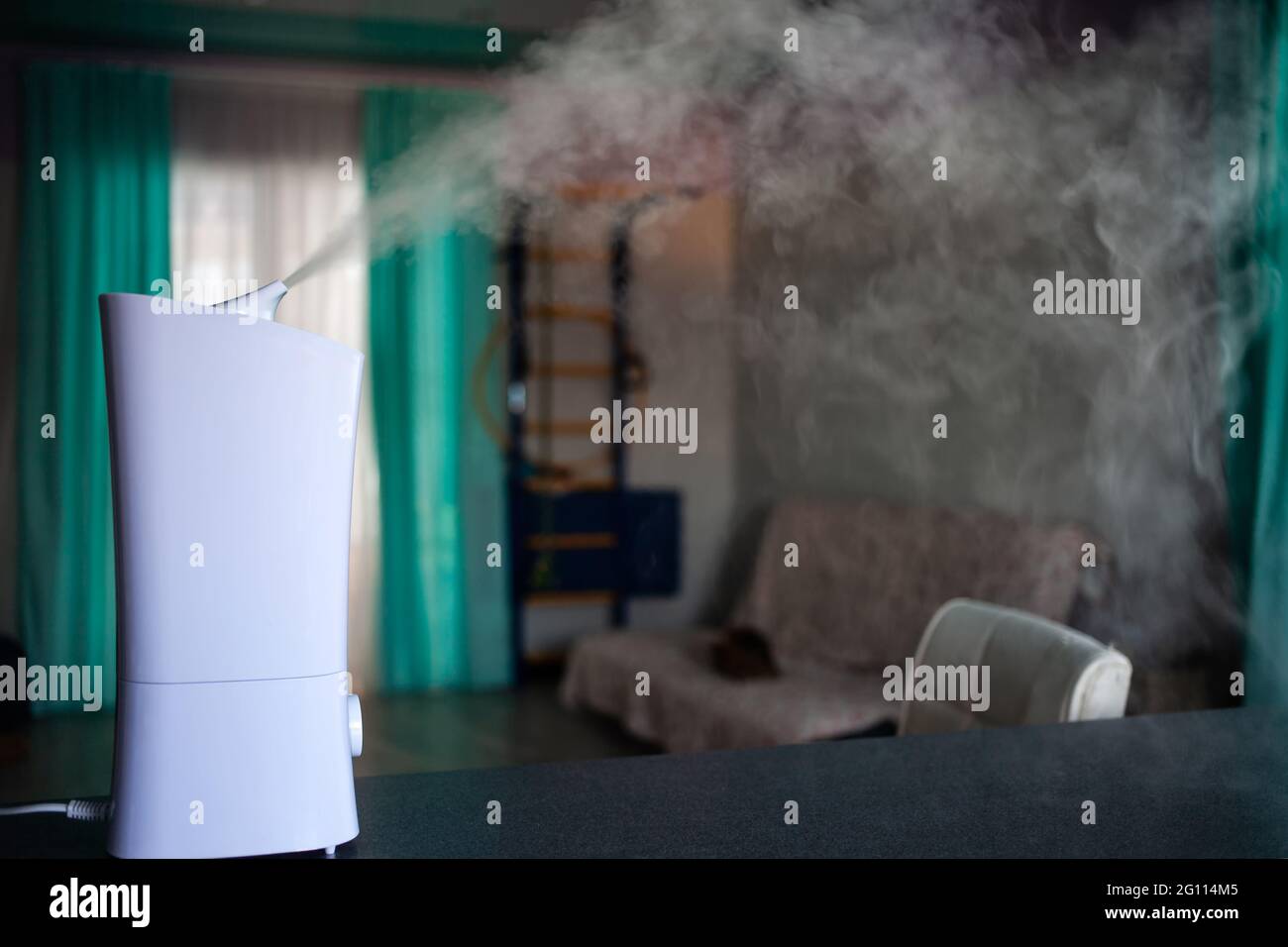 Humidifier spreading steam into the living room Stock Photo - Alamy