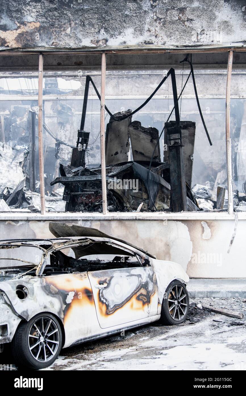 Munich, Germany. 04th June, 2021. A burnt Mercedes hangs on the remains ...
