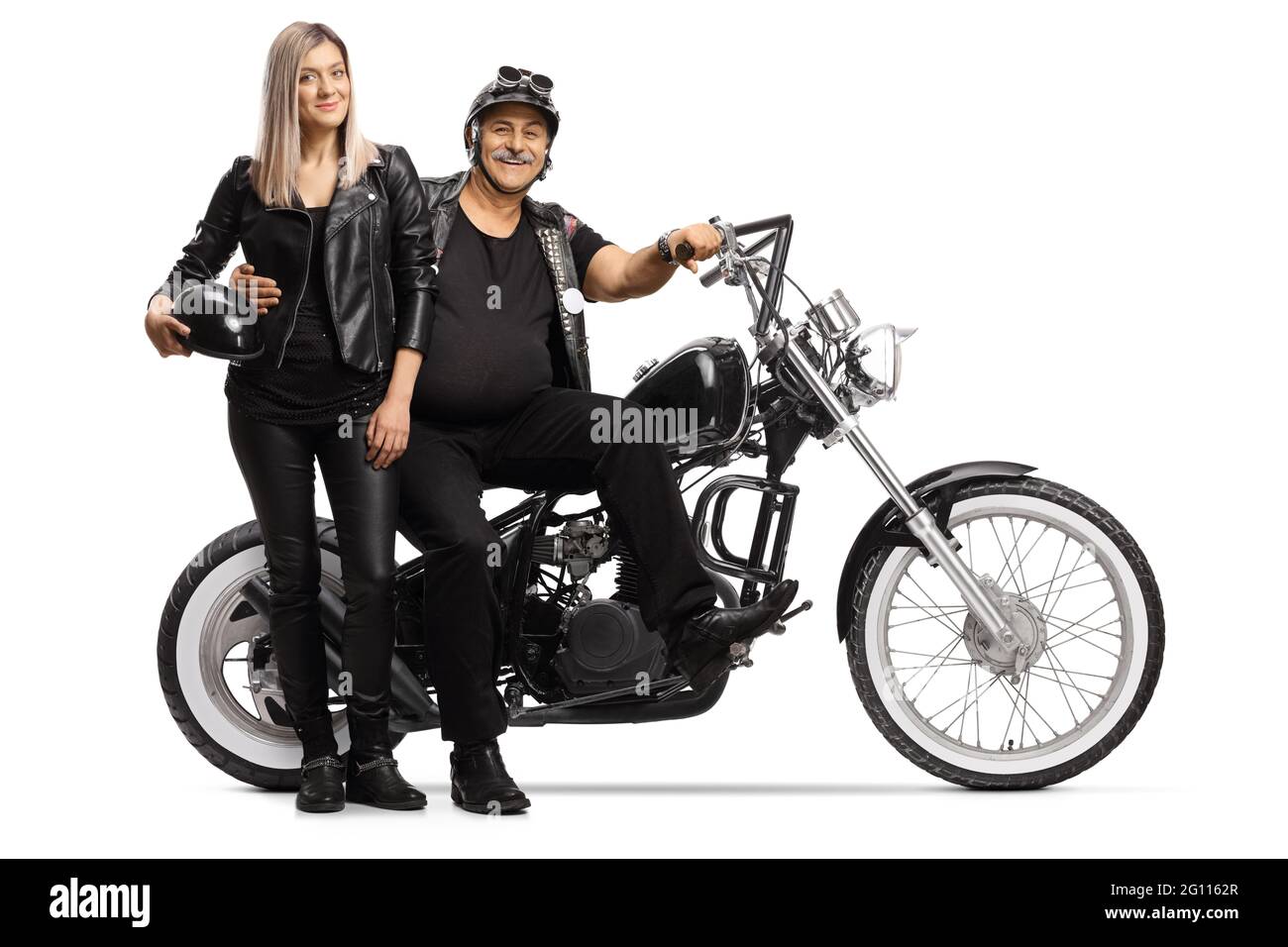 Mature biker and a young woman in leather clothes standing next to his ...