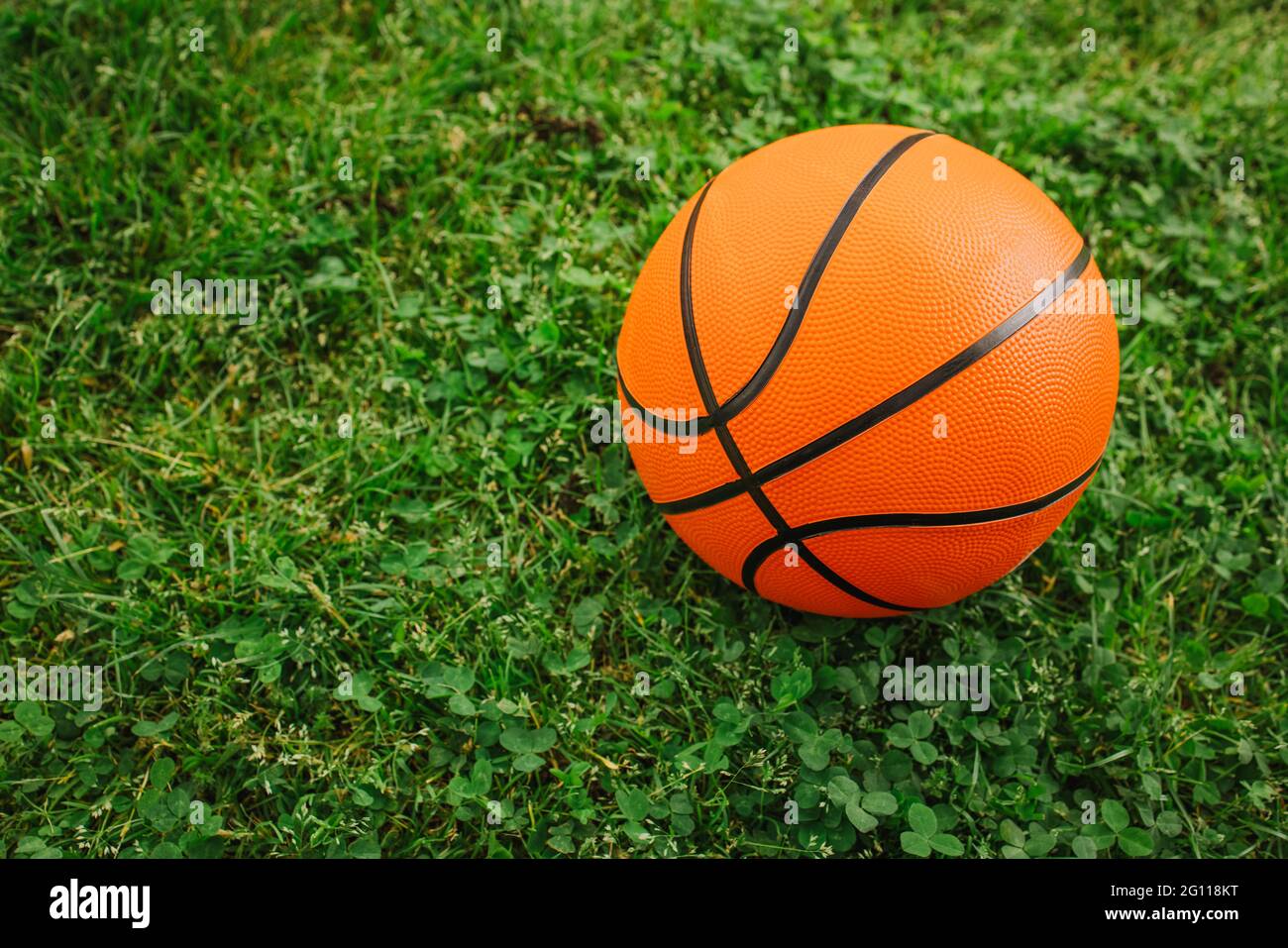 Basketball ball on a fresh green grass. Outdoor kids playground Stock ...