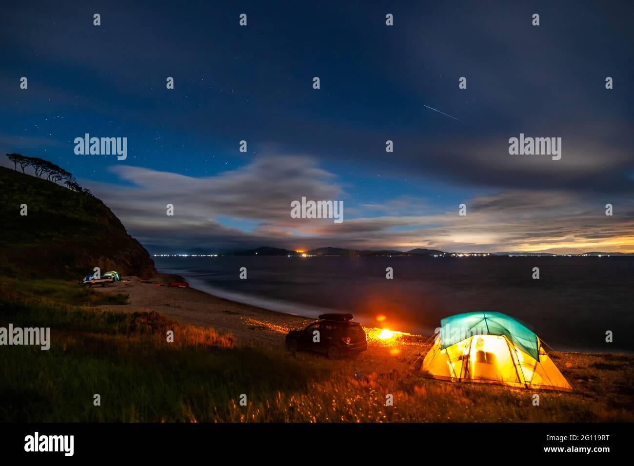Tent camping at the sea coast in the night. Some noise from high iso ...
